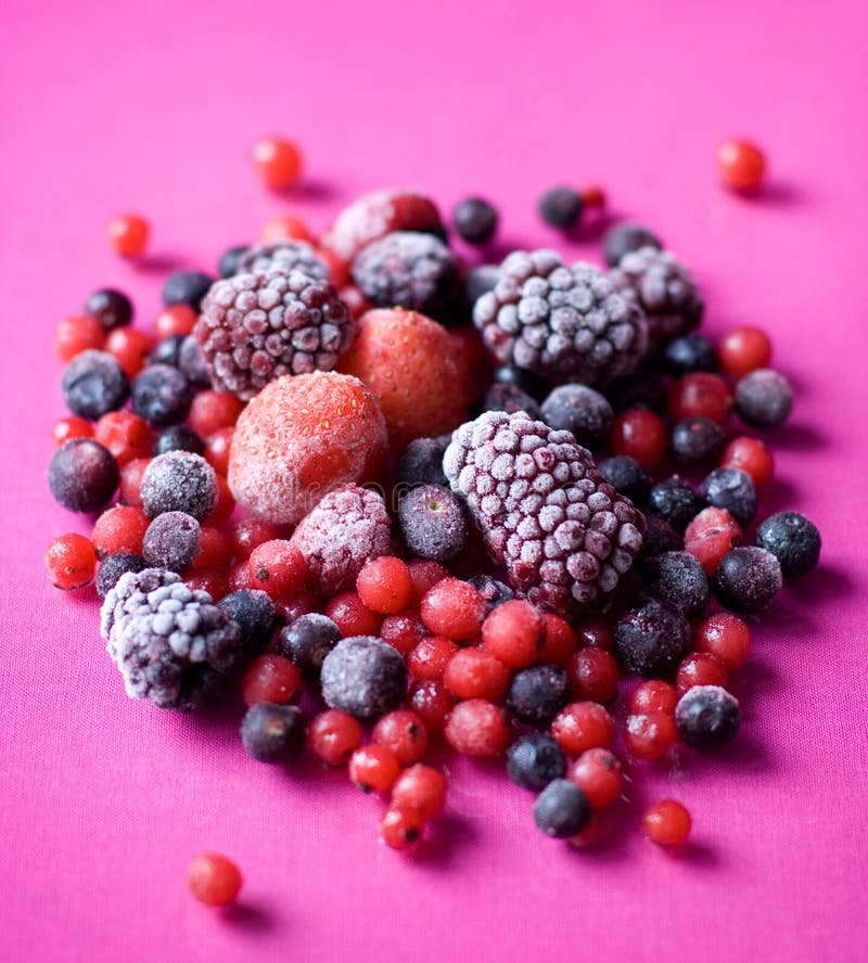 Beauty Fashion Model Girl Lying in Fresh Ripe Berries. Face in Colorful ...