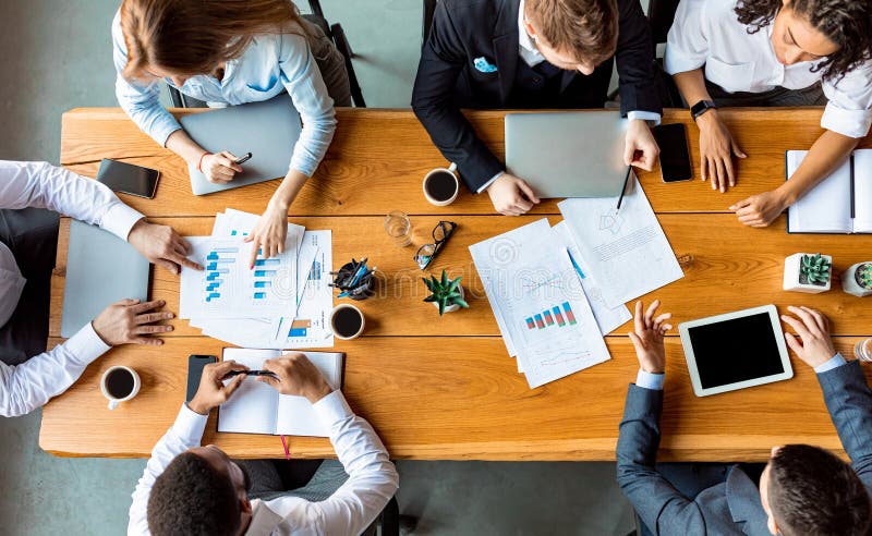 Mixed Business Team Working Sitting at Table in Office, Above-View ...