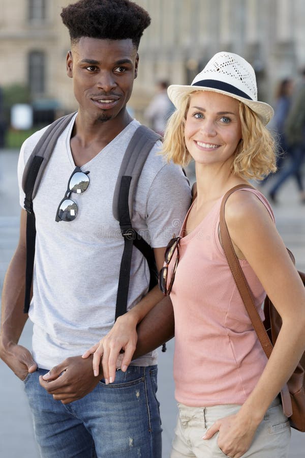 Mixed couple on holidays stock photo. Image of girl - 264988328
