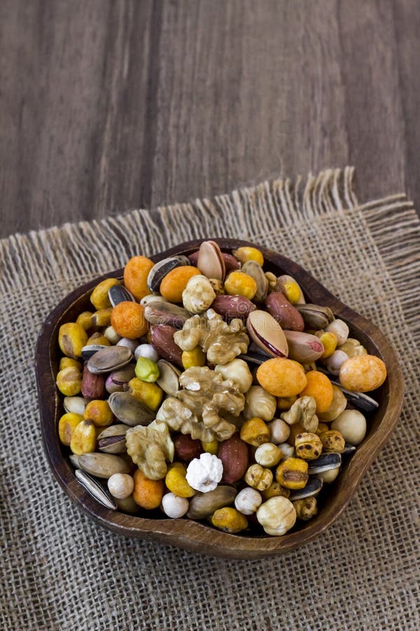 Crispy, Dry Nuts in a Wooden Plate on Wooden Table,with Jute Napkin ...