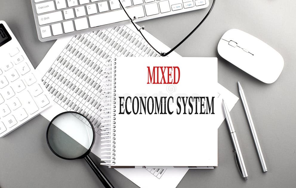 MIXED ECONOMIC SYSTEM Text on Notebook with Clipboard and Calculator on ...