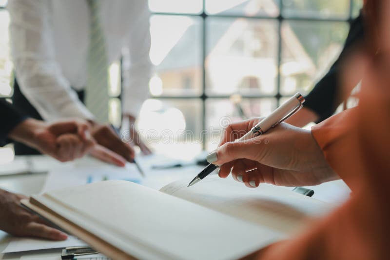 Mixed Group of Business People Sitting Around a Table and Working ...