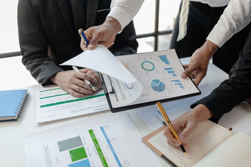 Mixed Group of Business People Sitting Around a Table and Working ...