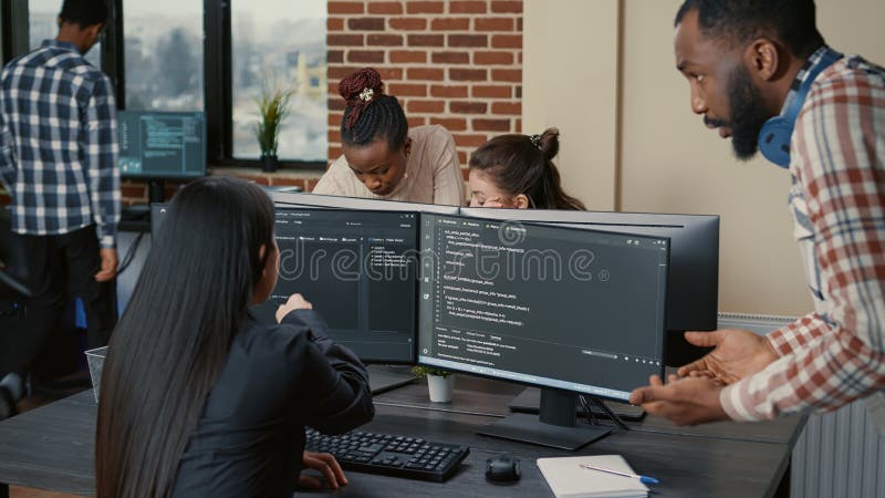 Mixed Programmers Team Working On Group Project On Multiple Screens