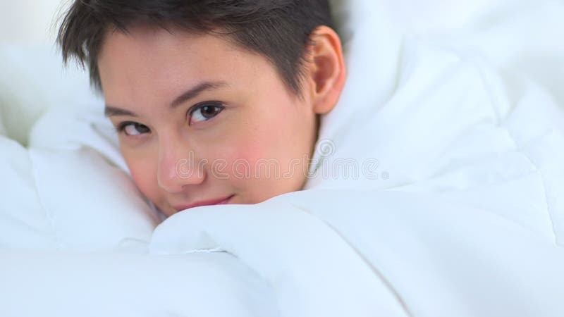 Mixed Race Asian Woman Smiling Under Sheets in Bed Stock Footage ...