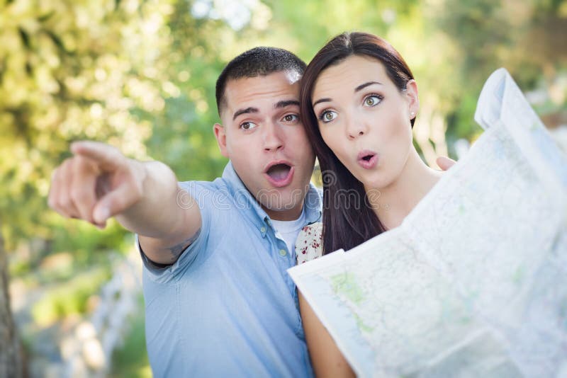 Mixed Race Couple Looking Over Map Outside Together Stock Photo - Image ...