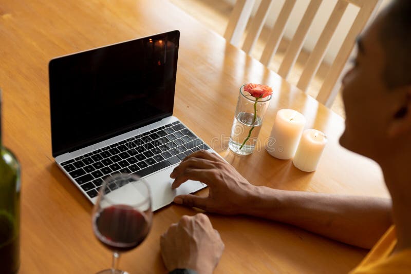 Mixed Race Man Sitting at Table Using Laptop Computer Stock Photo ...