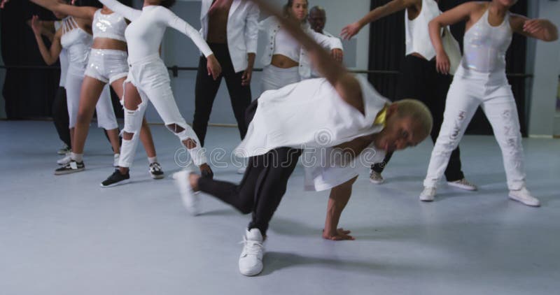 Multi-ethnic Group of Fit Male and Female Modern Dancers Practicing a ...