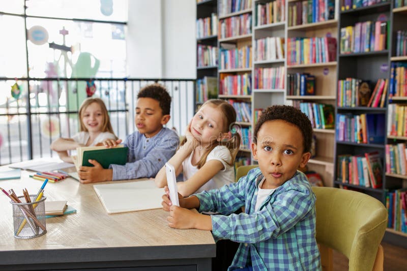 Multiracial Group of Children Sitting in Row at School Classroom and ...
