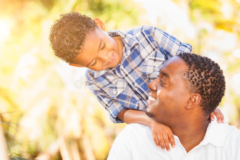 Mixed Race Son And African American Father Playing Outdoors Together