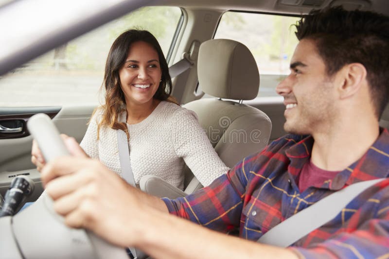 Mixed Race Young Couple Smiling in a Car on a Road Trip Stock Image ...