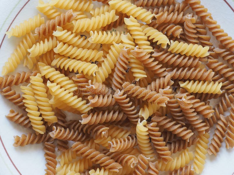 Mixed Regular and Whole Wheat Fusilli Pasta Background Stock Photo ...