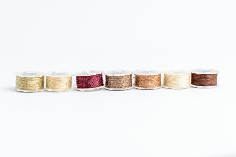 Mixed Spools of Beige and Brown Threads Prepared for the Sewing Machine ...