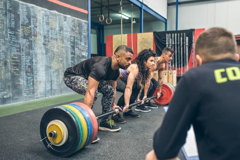 Mixed Team Lifting Weights in the Gym with Their Coach Stock Image ...