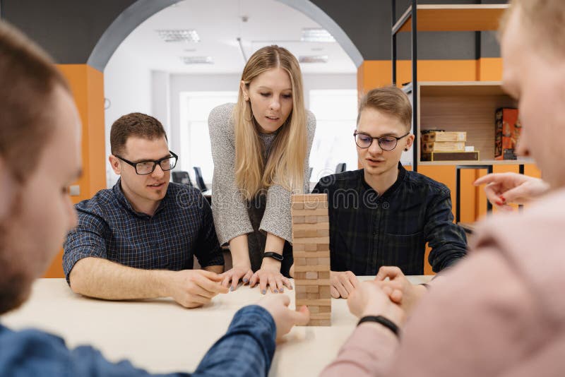 Mixed Team Playing Blocks Wood Game in the Office Stock Photo - Image ...