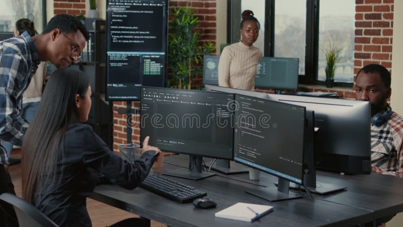 Mixed Team Of Programmers Analyzing Source Code Pointing At Screens Comparing Algorithm Stock