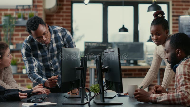 Mixed Team of Programmers Brainstorming Ideas for New Cloud Computing User Interface Looking at ...
