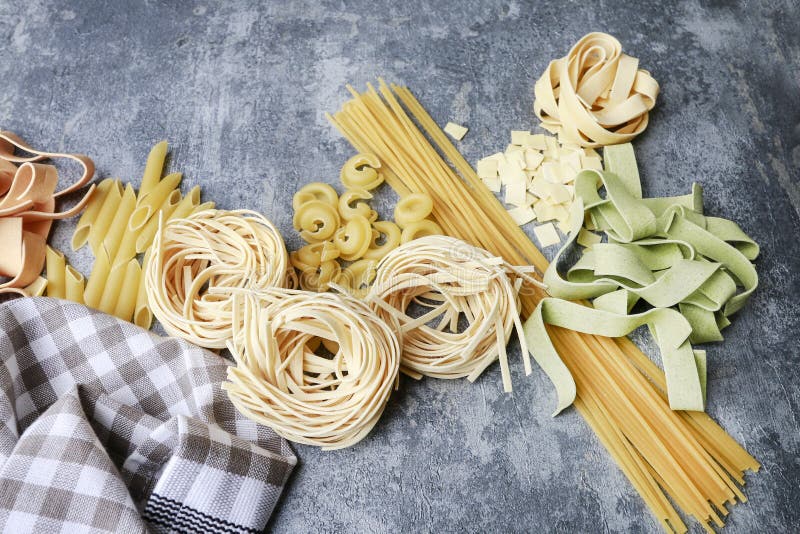 Mixed Types and Shapes of Italian Pasta on Grey Stone Background Stock ...