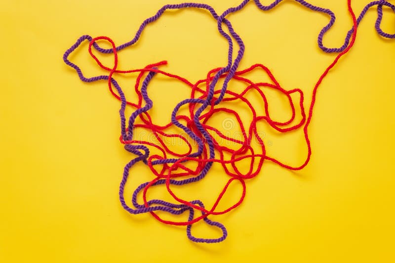 Mixed Up Red and Blue Wool Threads Lie on a Yellow Background Stock ...