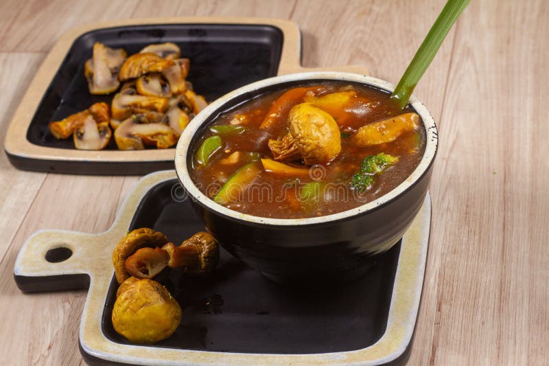 Mixed Vegetable Soup Served in Clay Pots, Topped with Fried Mushrooms ...