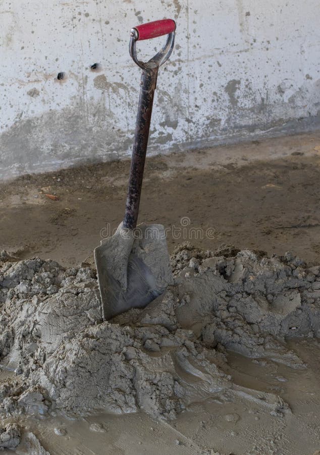 Wet cement and a spade stock photo. Image of concrete - 111916802