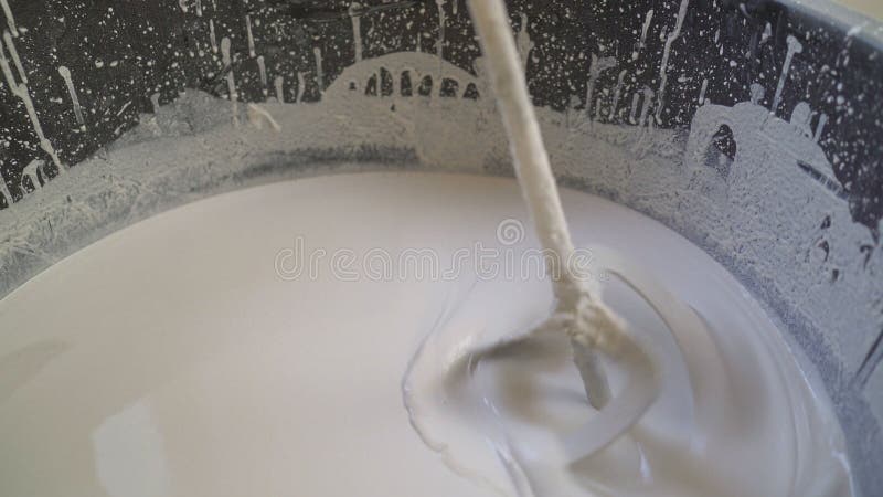 The Primer is Mixed in a Large Bucket Using a Construction Mixer. the ...