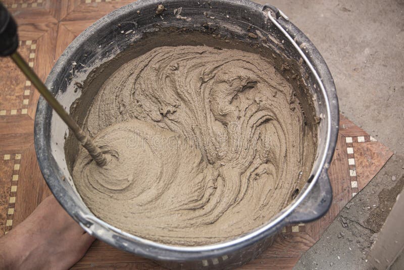 Mixing Cement Adhesive with a Mixer in a Bucket Close-up, Texture of a ...