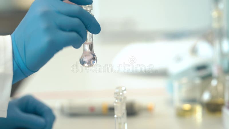 Mixing a Chemical Solution in a Glass Flask during Research in a ...