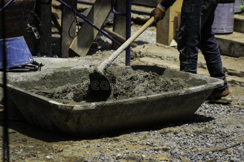 Mixing concrete with sand stock photo. Image of build - 89686262