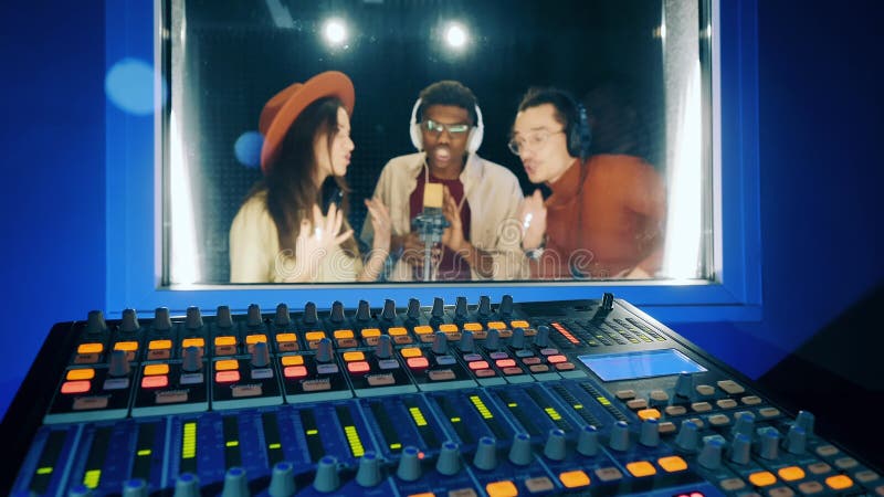 Mixing Console in a Music Studio with Young People Singing in it Stock ...