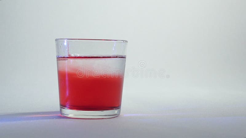 Mixing of Liquids in a Glass or Dissolution Stock Footage - Video of ...