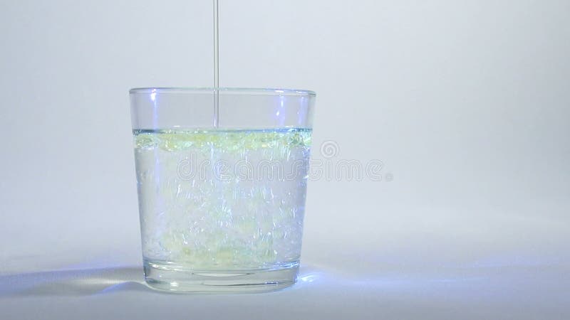 Mixing of Liquids in a Glass or Dissolution Stock Footage - Video of ...