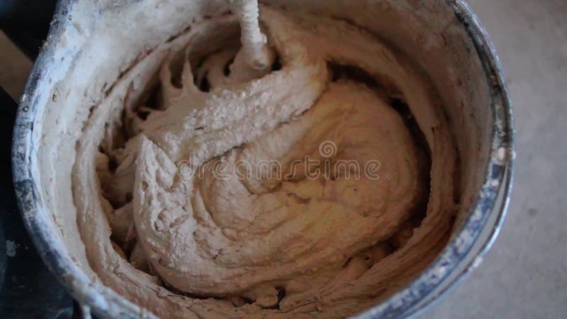 Mixing mortar in a bucket stock footage. Video of material - 127744140