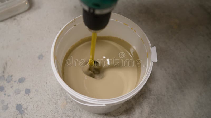 A Bucket of Hedgehog Paint Mixing in Motion. a Painter Mixes Paint ...