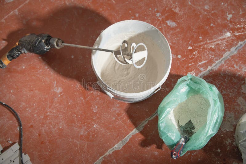 Mixing of Putty. Construction Mixer in a Bucket Stock Image - Image of ...