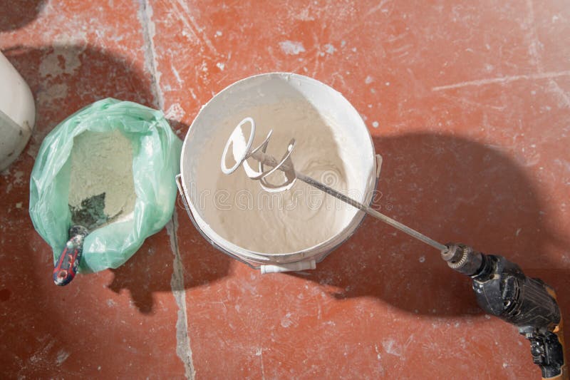 Mixing of Putty. Construction Mixer in a Bucket Stock Photo - Image of ...