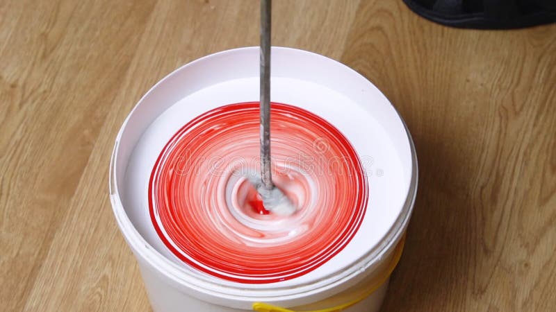 Mixing Red Paint with White Paint Using a Construction Mixer Stock ...
