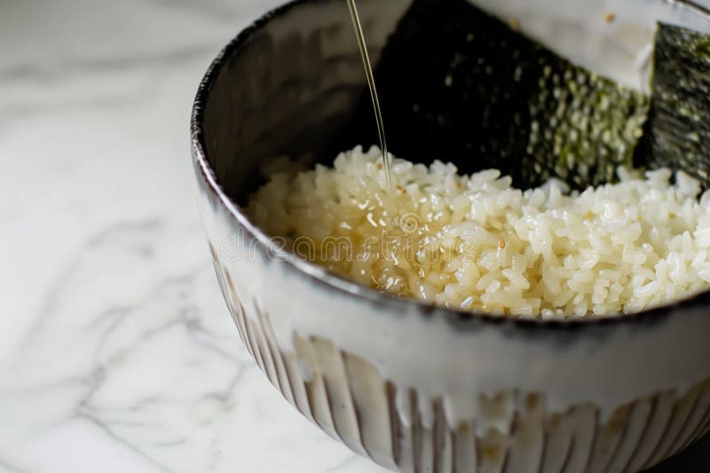 Mixing Rice Vinegar into Sushi Rice in a Bowl Stock Photo - Image of ...