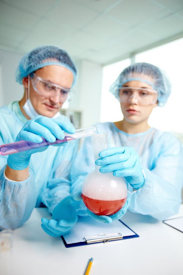 Mixing up two substances stock photo. Image of female - 25443002
