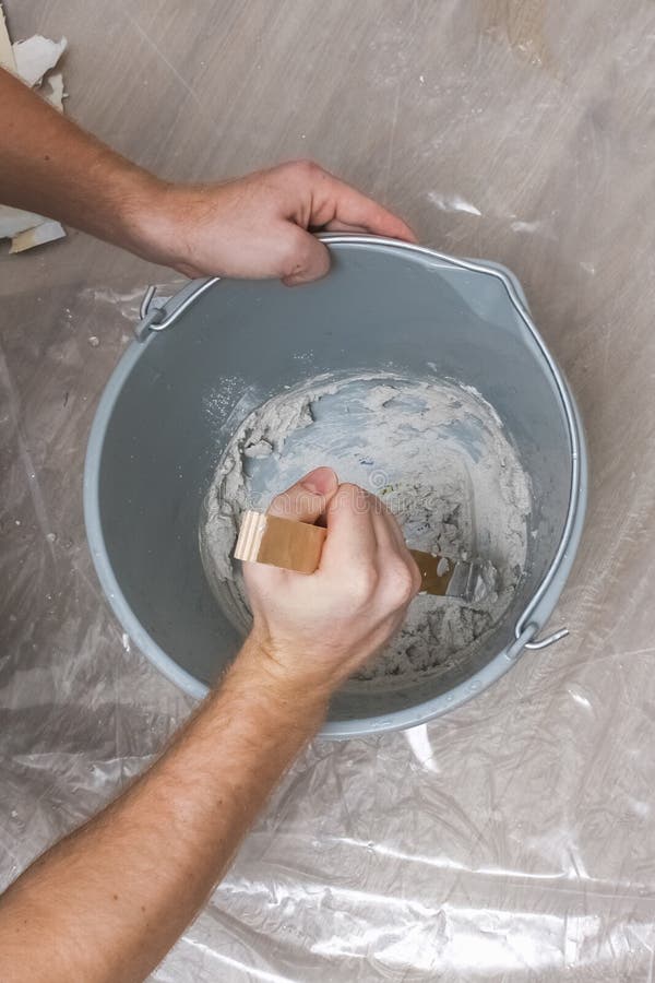 Mixing White Plaster in a Bucket with Stirrer. Close-up. Stock Photo ...