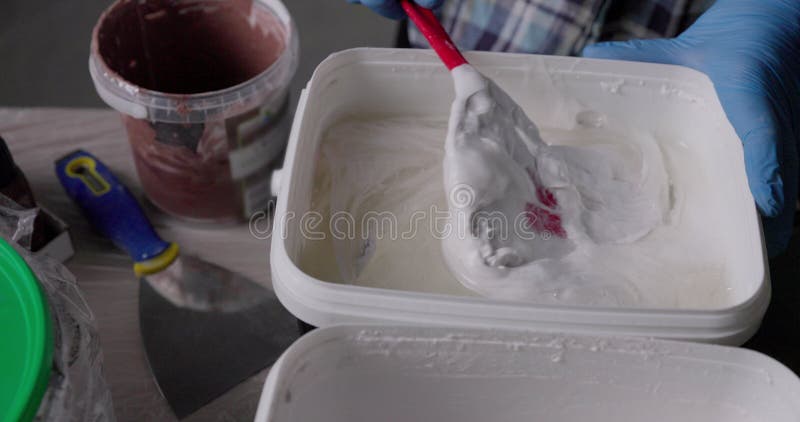 Mixing a White Substance Using a Spatula within a Container for Various ...