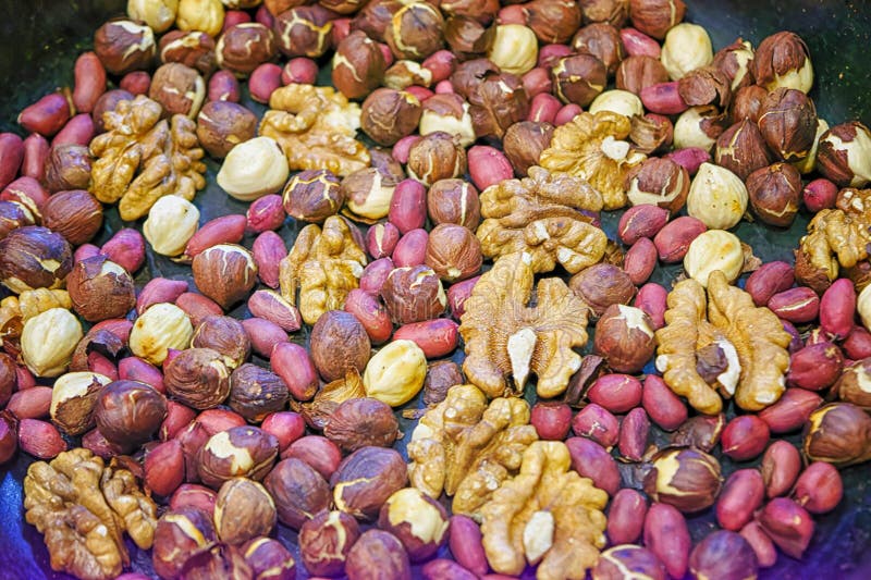 A Mixture of Roasted Walnuts, Hazelnuts and Peanuts in a Pan Close-up ...