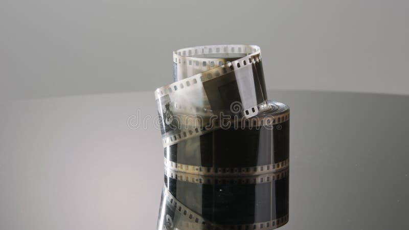 35mm Film Negative Rotating on a Reflective Surface. Studio Shot Stock ...