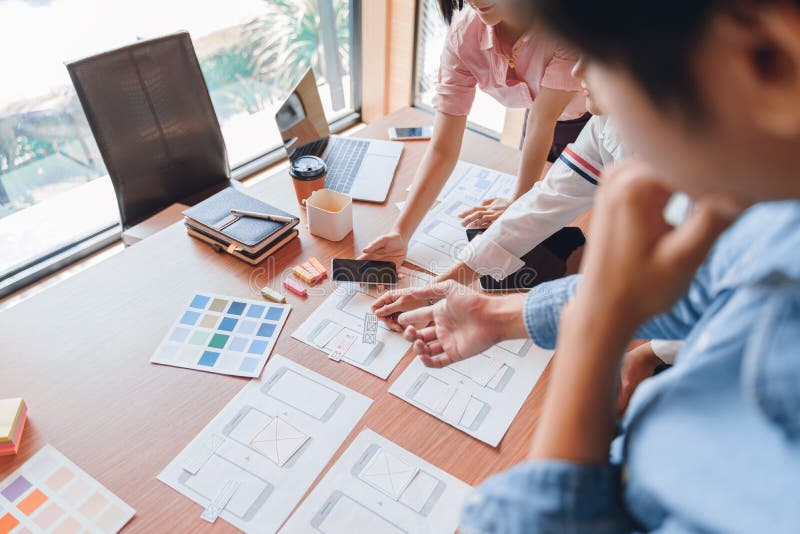 Mobile Apps Developers Team Designing Discussing Together On A User Interface Wireframe Screens