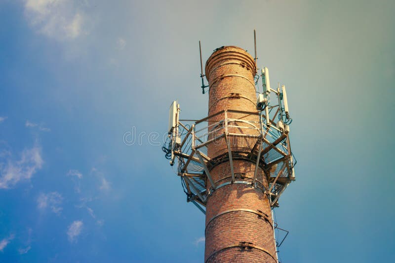 Communication Transmitters on a Concrete Pole Against the Blue Sky ...