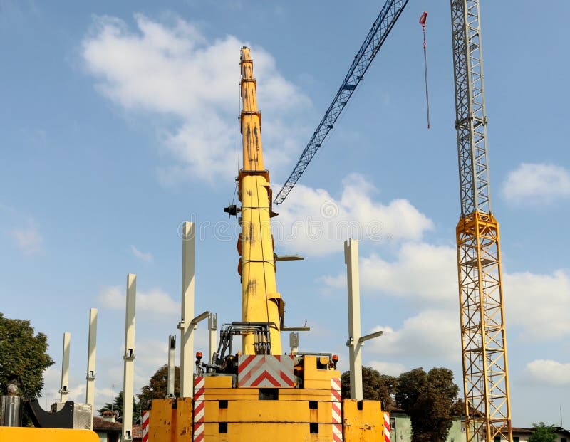 Mobile Crane and Tower Crane with the Main Pillars of the New Building ...