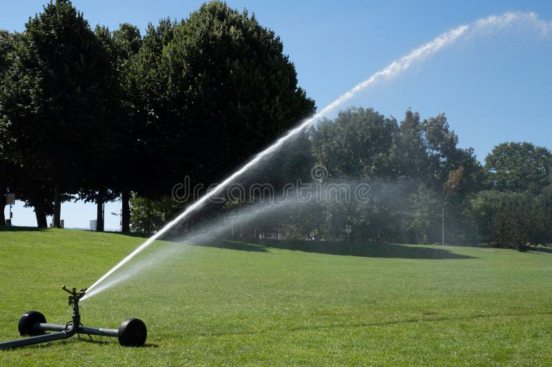 Mobile Irrigation System Water on a Green Lawn Stock Image - Image of ...
