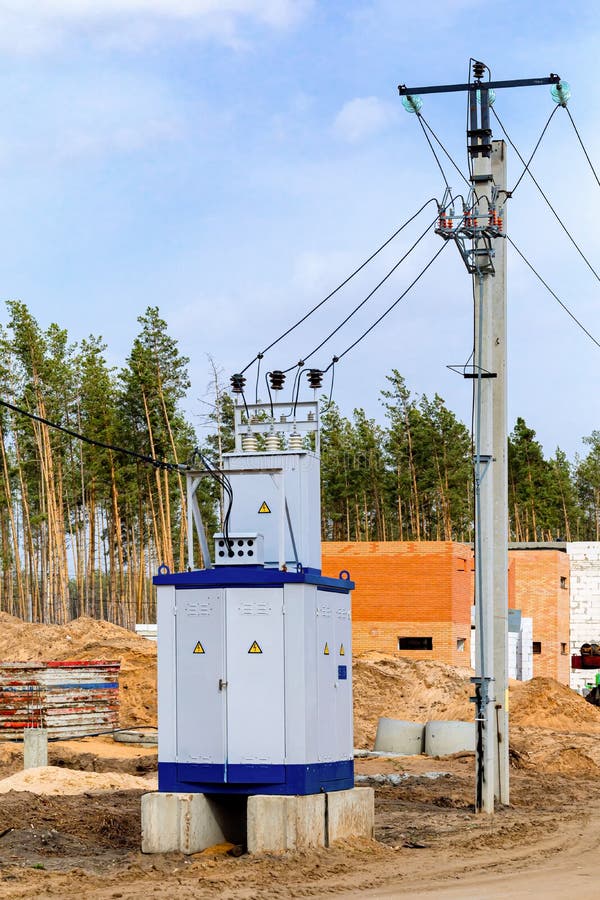 A Mobile Live Transformer Booth Stands Near High Voltage Poles on a ...