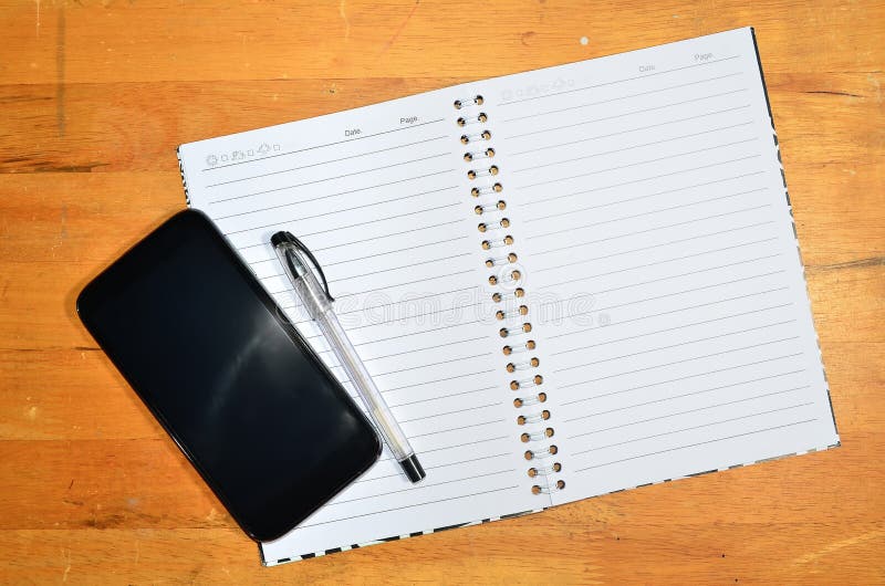 Mobile and Notebook on Wooden Table Stock Image - Image of note ...