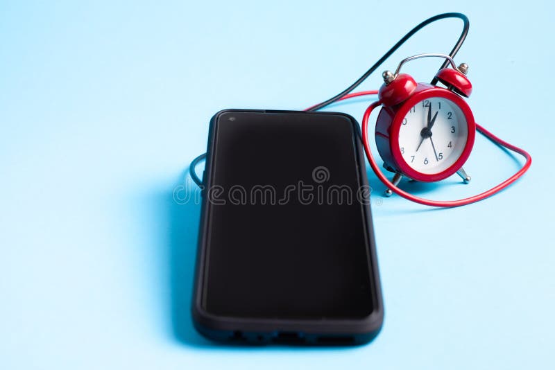 Mobile Phone and Alarm Clock Stock Image - Image of electrical, cable ...